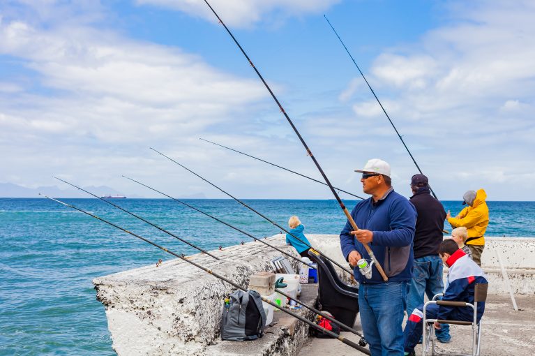 Recreational anglers fishing off Kalk Bay harbour wall. Photo ...